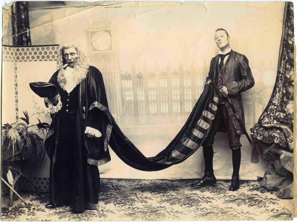 Two male theatrical characters. One wearing a Judge's/nobleman's ...